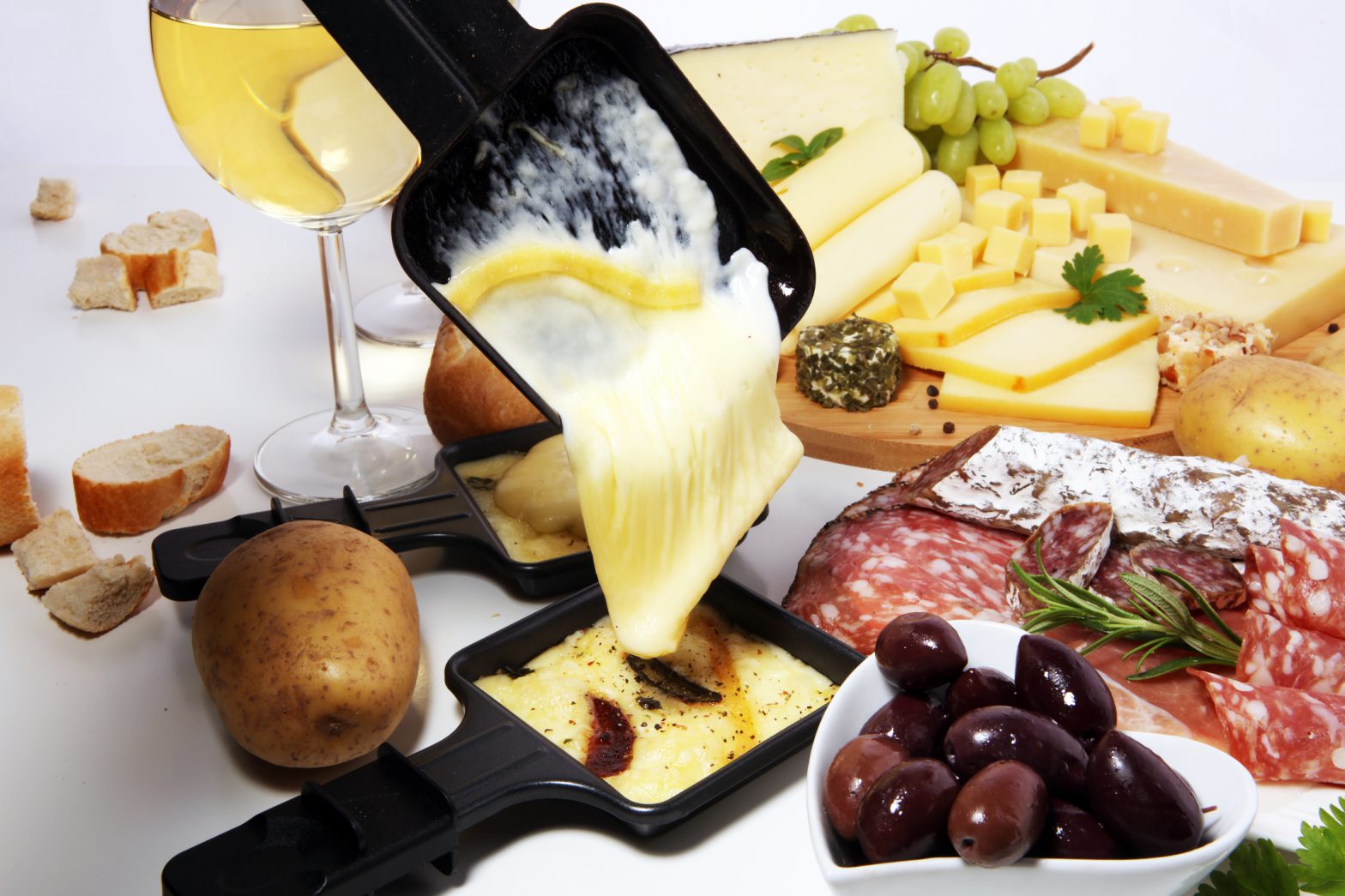 Delicious traditional Swiss melted raclette cheese on diced boiled or ...